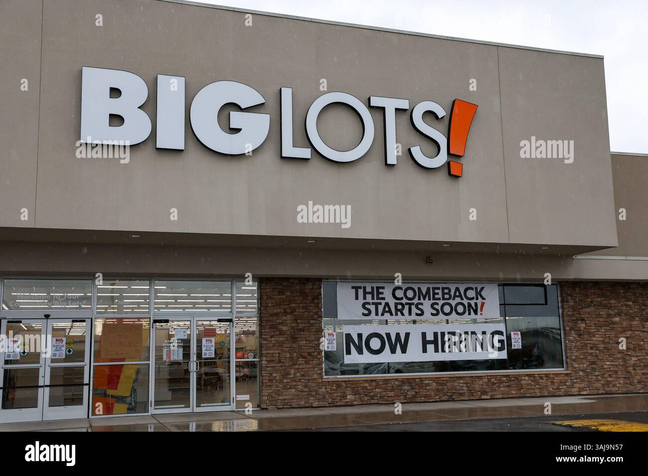 A now hiring sign is seen on the window of a closed Big Lots store ...
