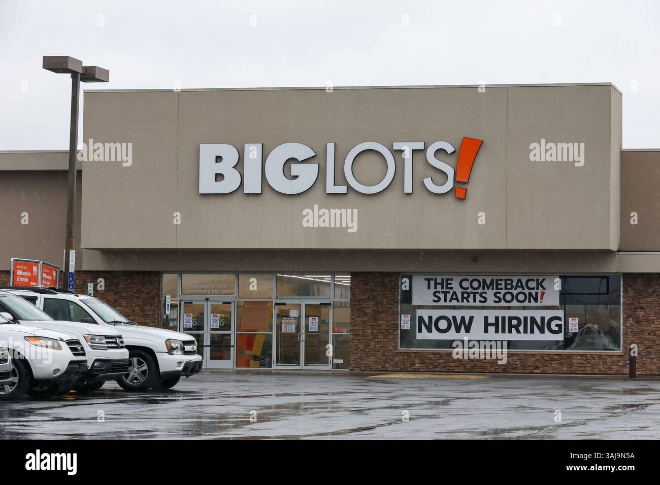 A now hiring sign is seen on the window of a closed Big Lots store ...