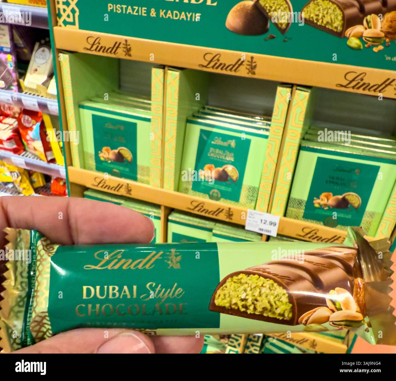 Customer holding a lindt dubai style chocolate bar with pistachios in ...