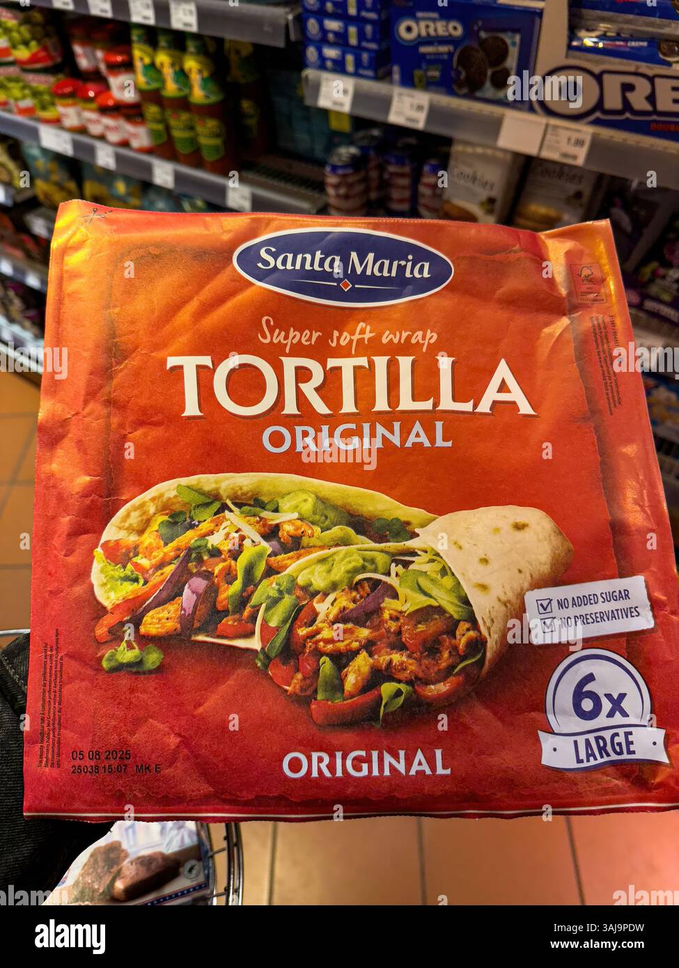 Shopper holds a package of santa maria original tortilla wraps while ...