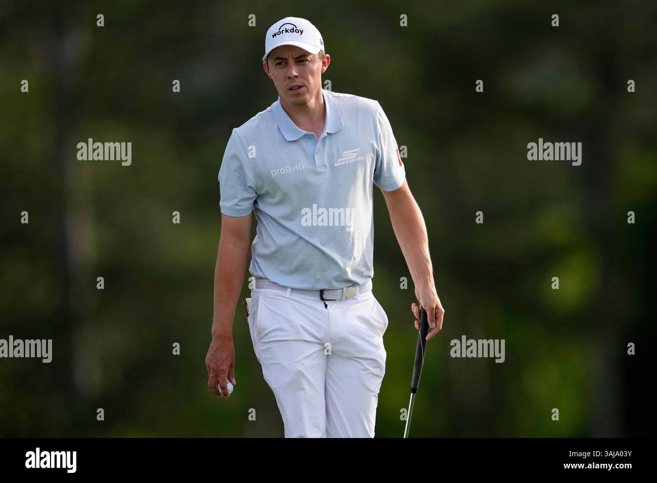 Matt Fitzpatrick, of England, walks off the green on the 18th hole ...