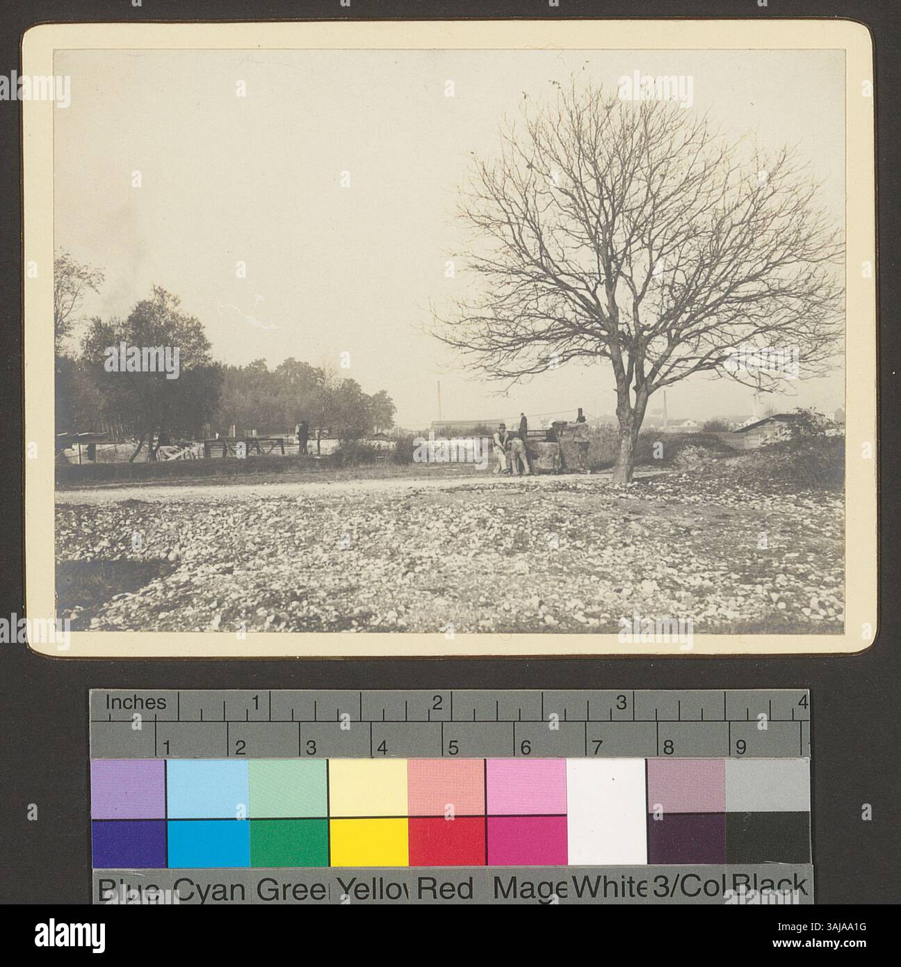 Photograph showing workers with a winch, presumably using a hand winch ...