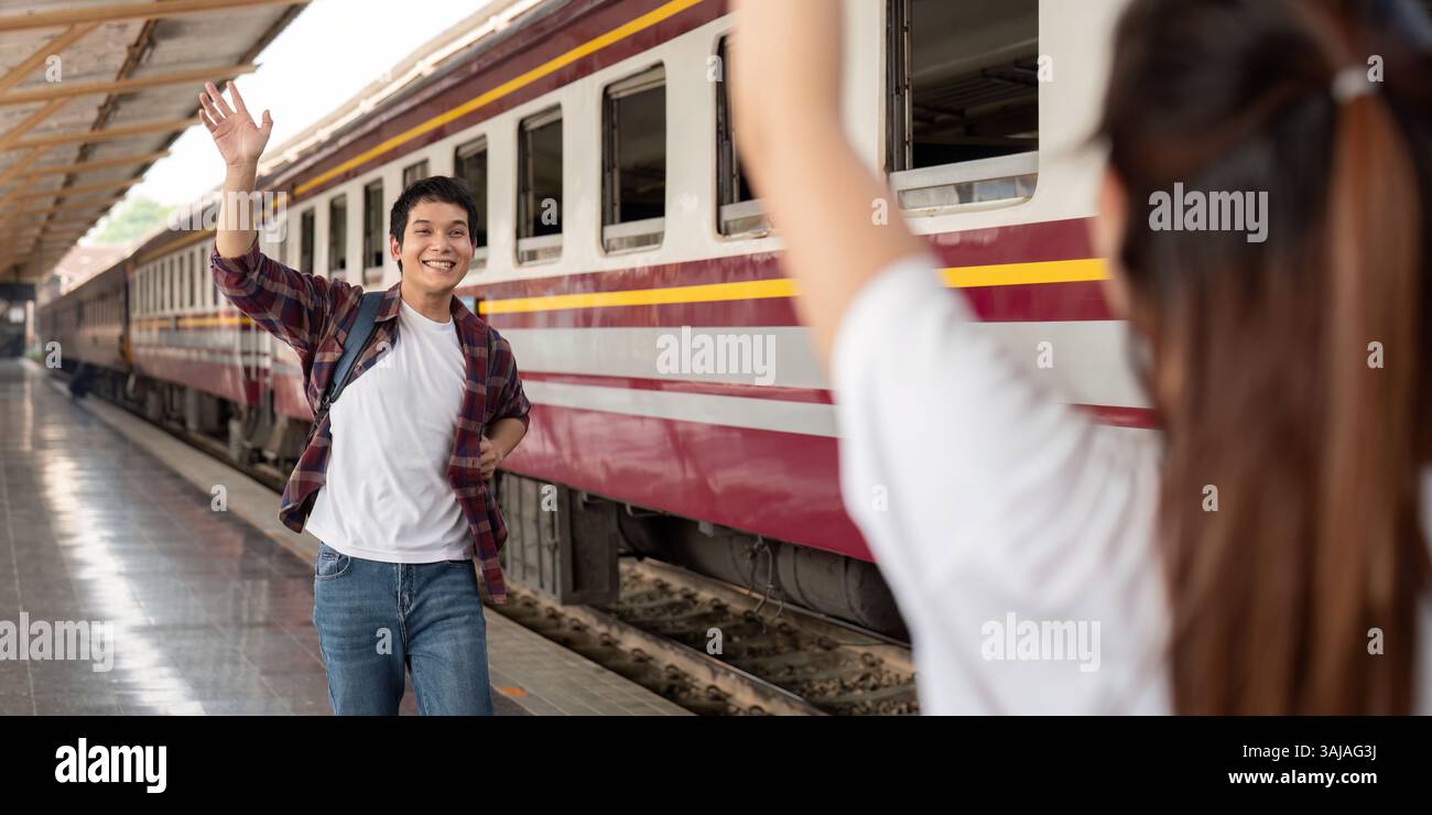 Travel and Farewell. A couple waves at the train station, expressing ...