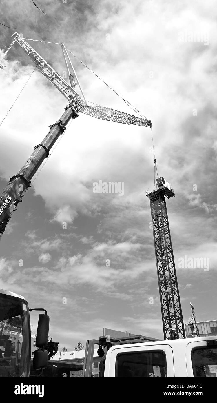 Tower crane construction; the jib is being placed on the tower Stock ...