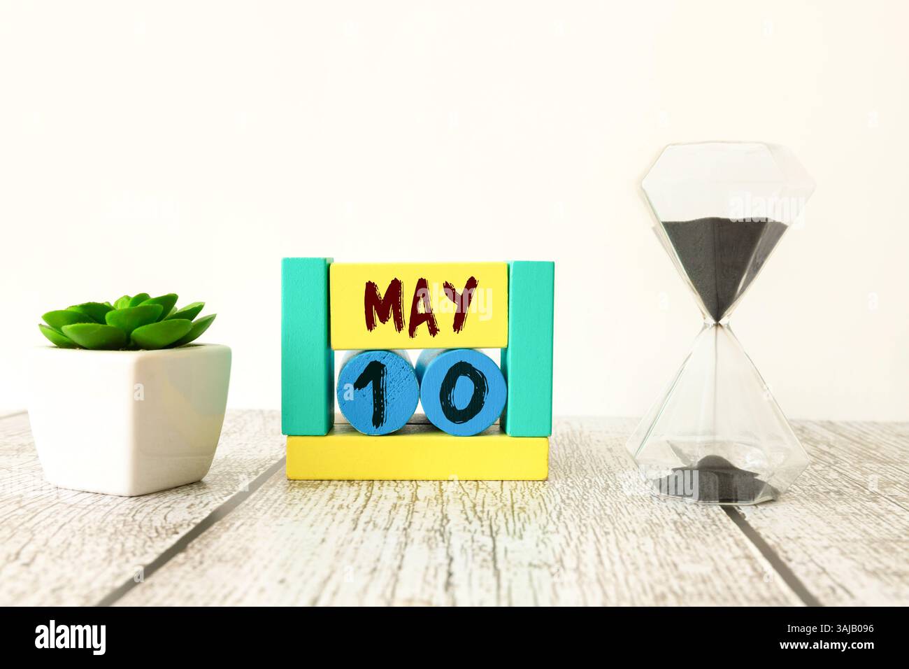 Wooden block calendar with date May 10 on a concrete background with ...