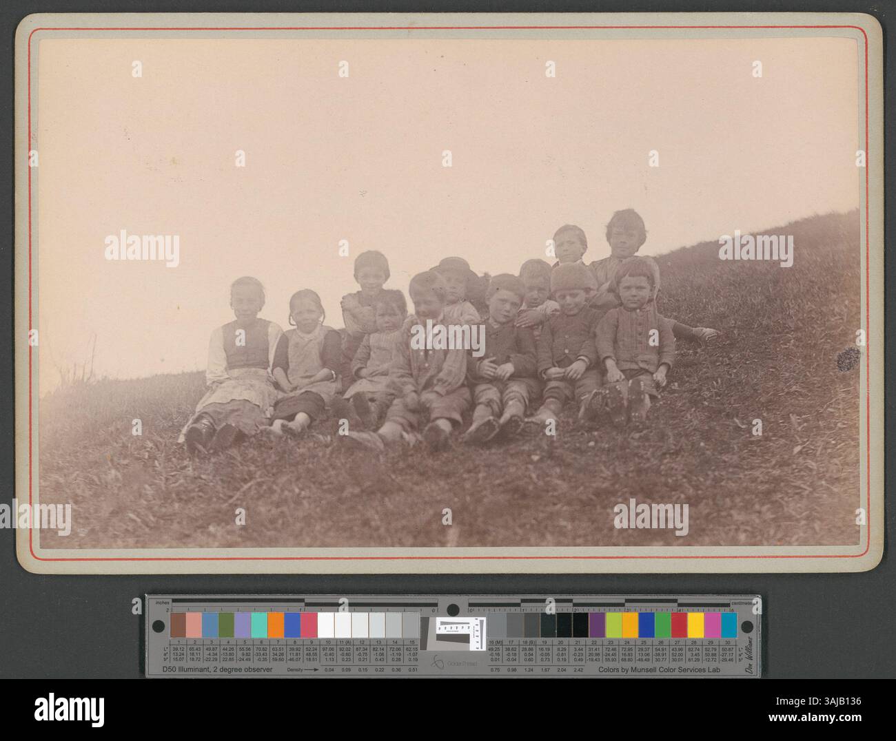 Photograph of twelve children sitting on the grass, taken in 1888 Stock ...