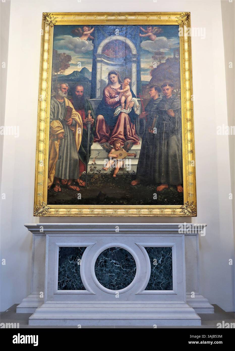 This painting, attributed to Francesco Vecellio, depicts the enthroned ...