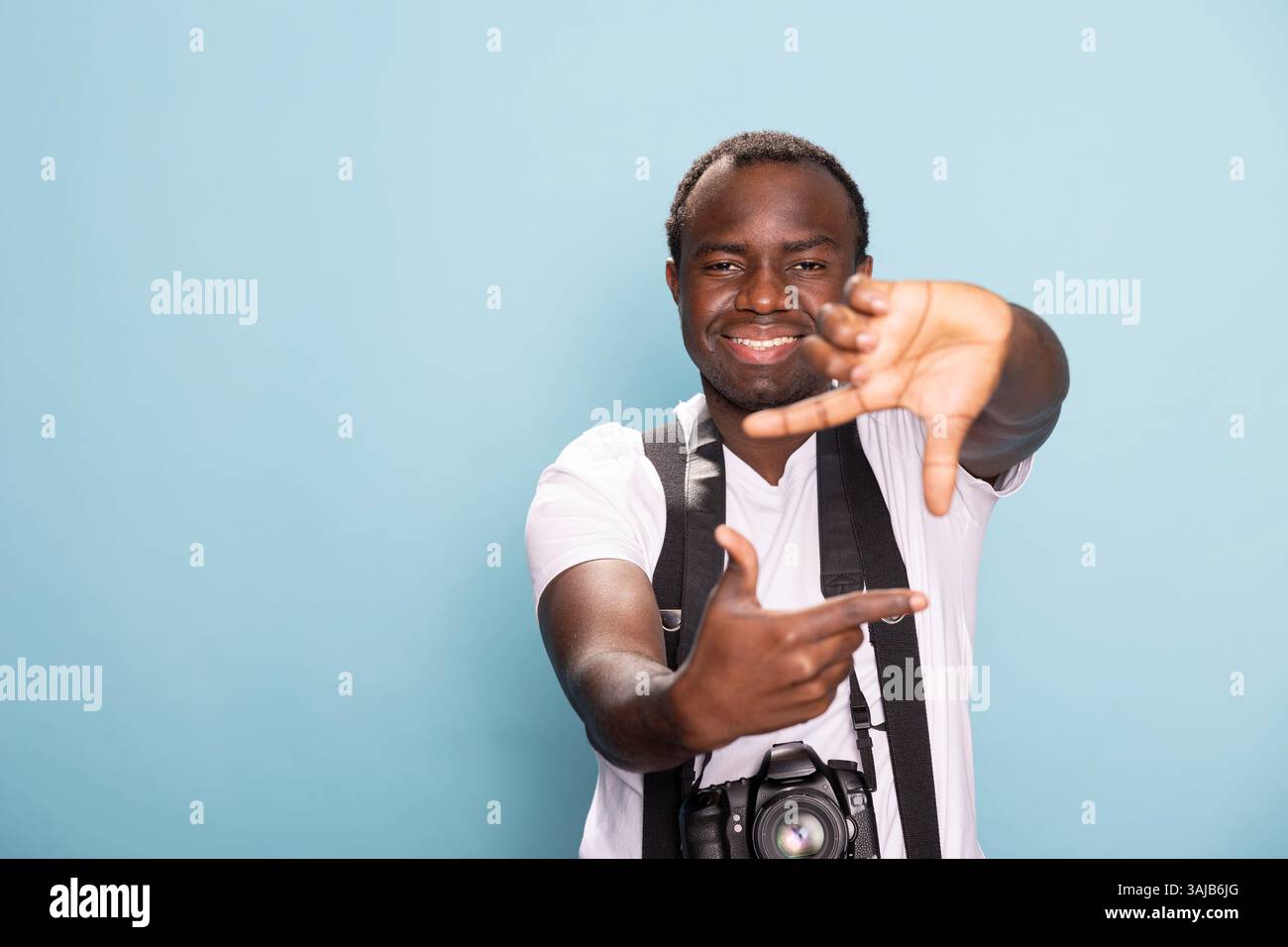 African American male photographer framing his shot without looking ...