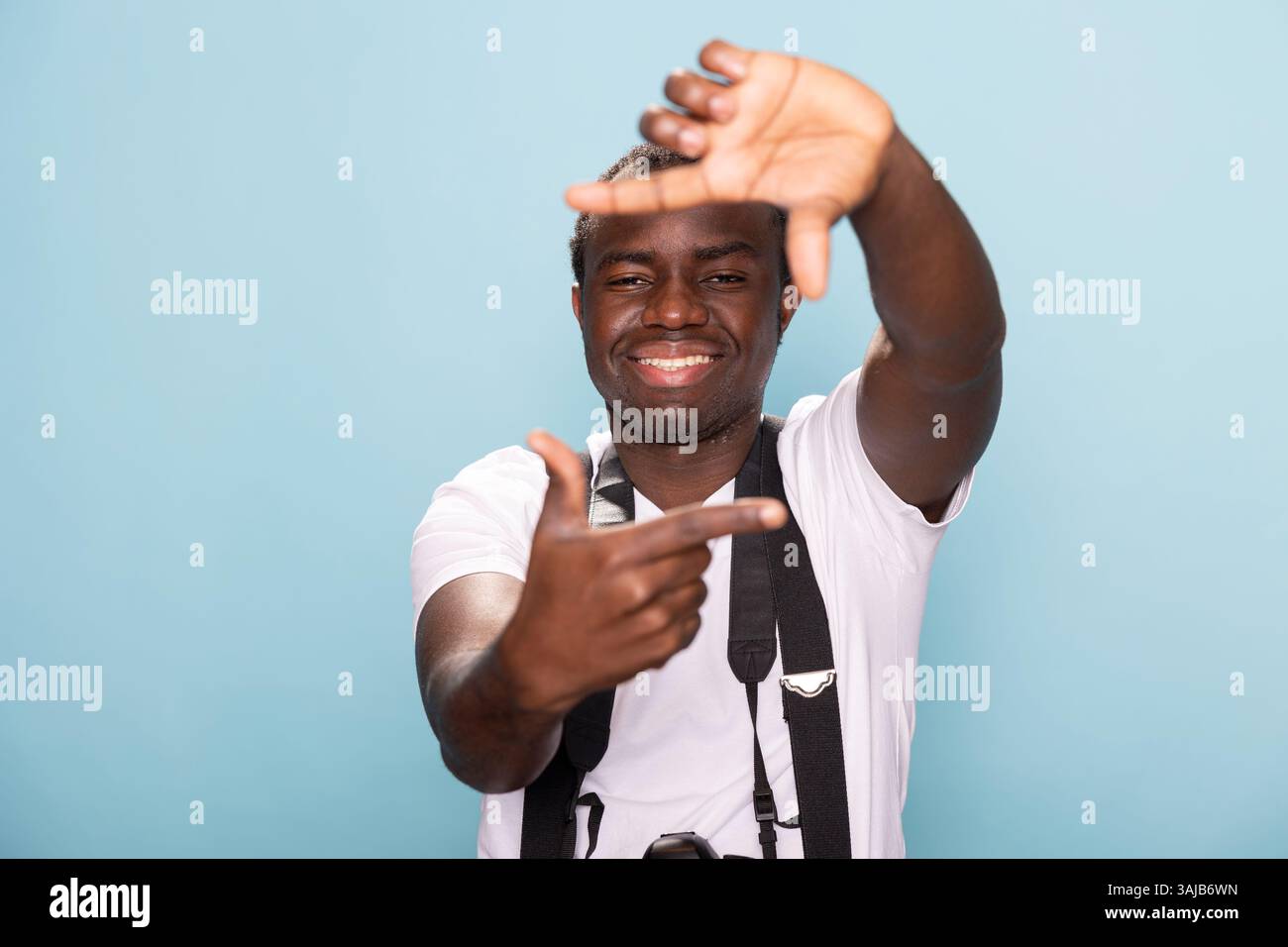 African American male filmmaker framing his shot with his fingers ...
