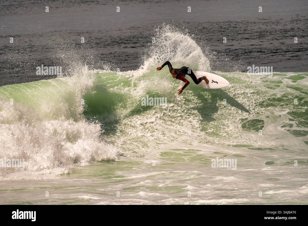 Surfer riding a wave at Reef spot in Pedra Branca beach, Ericeira, part ...
