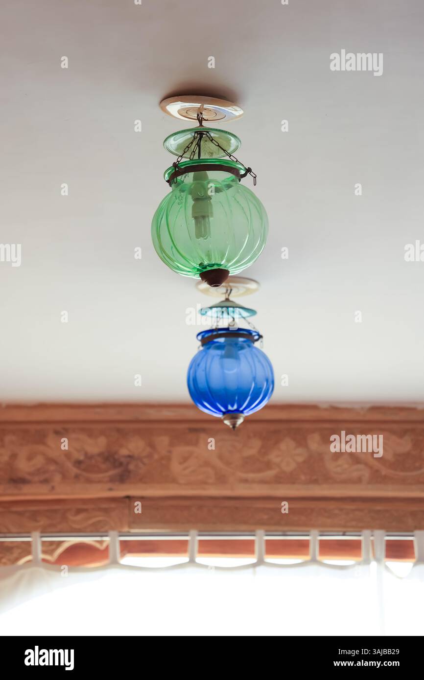 Two colorful traditional ceiling lamps on white ceiling Stock Photo - Alamy