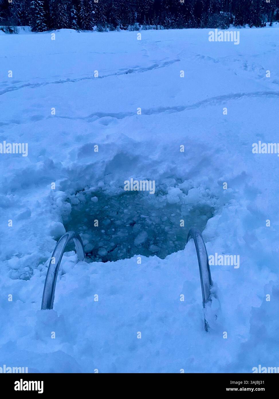 Ice Hole with Ladder in Frozen Lake Stock Photo - Alamy