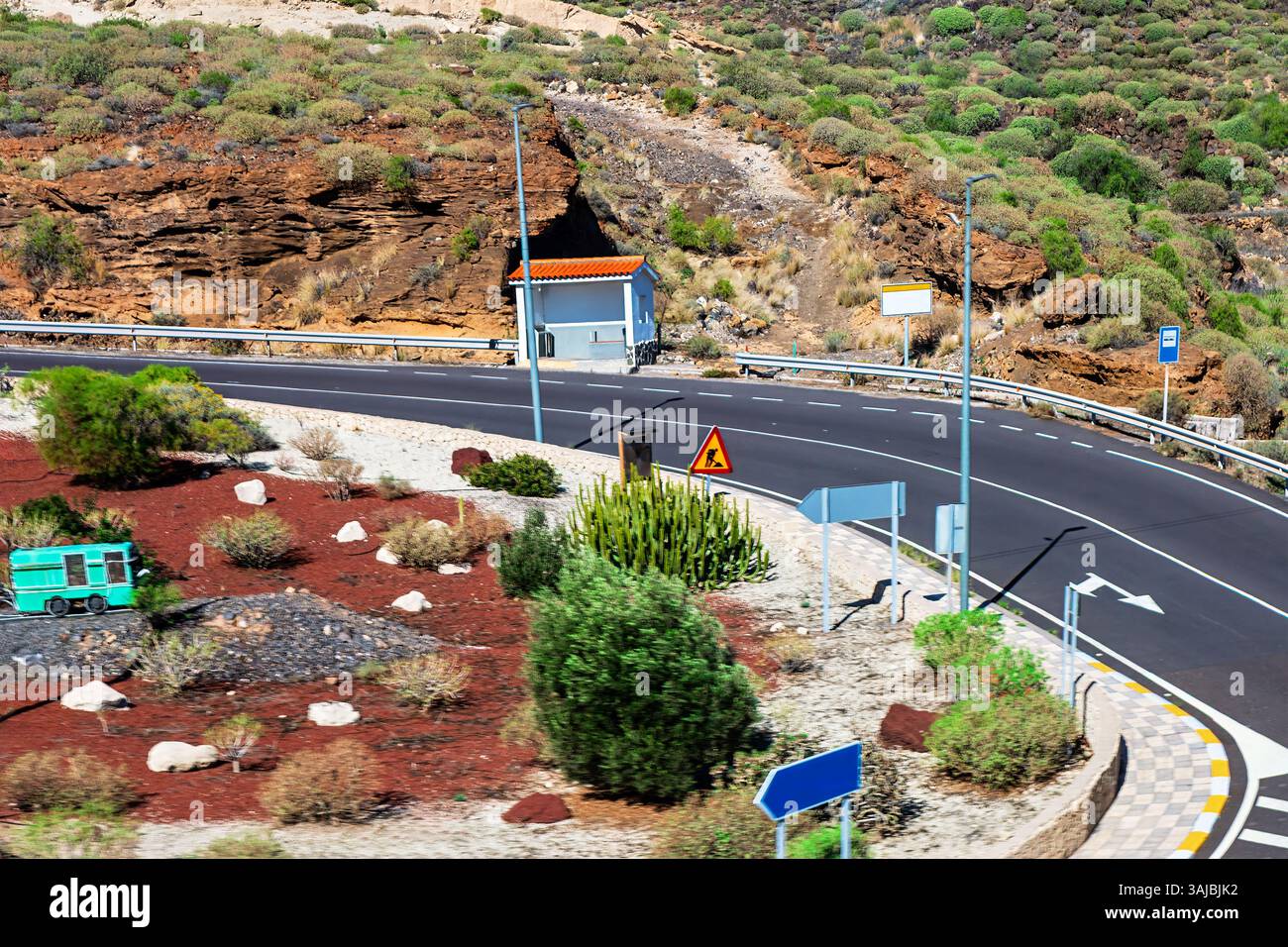 Winding mountain road curves through a rugged landscape with rocky ...