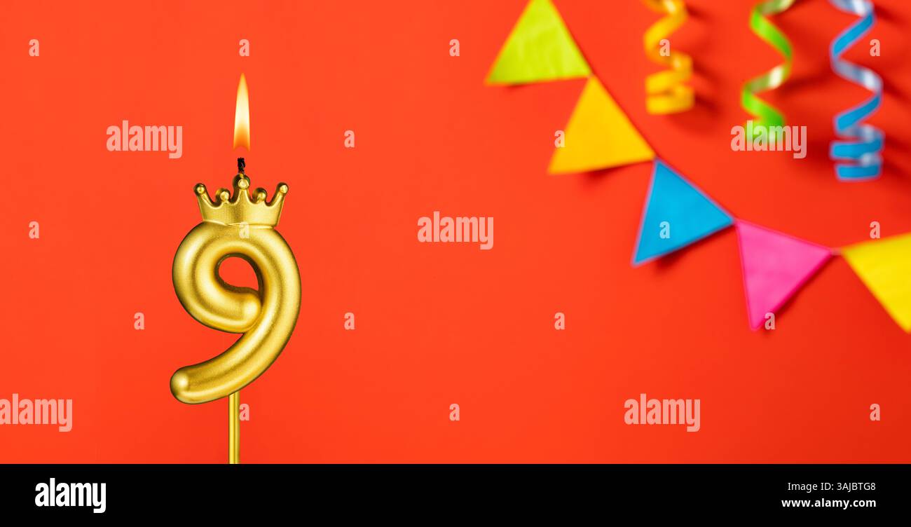 Number 9 birthday candle on an orange background with pennants Stock ...