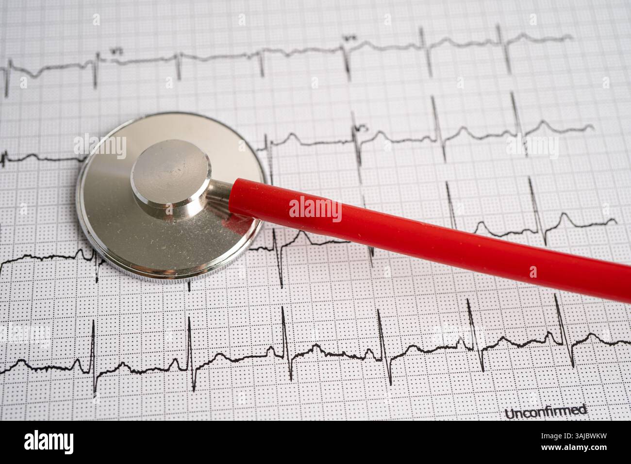Stethoscope on electrocardiogram ECG with red heart, heart wave, heart attack, cardiogram report ...