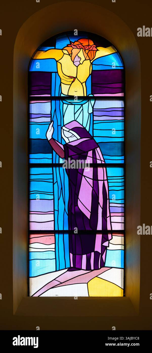 The Virgin Mary embracing Jesus on the Cross. A stained-glass window in ...