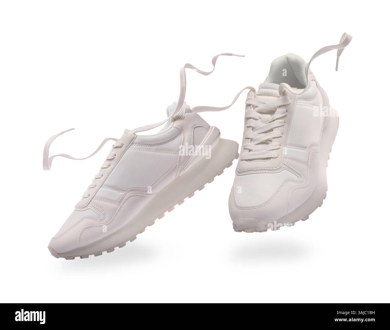Stylish sneakers in air on white background Stock Photo - Alamy