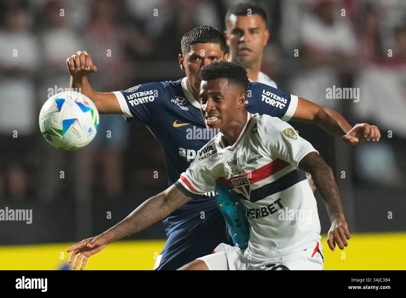 Marcos Antonio of Brazil's Sao Paulo, front, and Jesus Castillo of Peru ...