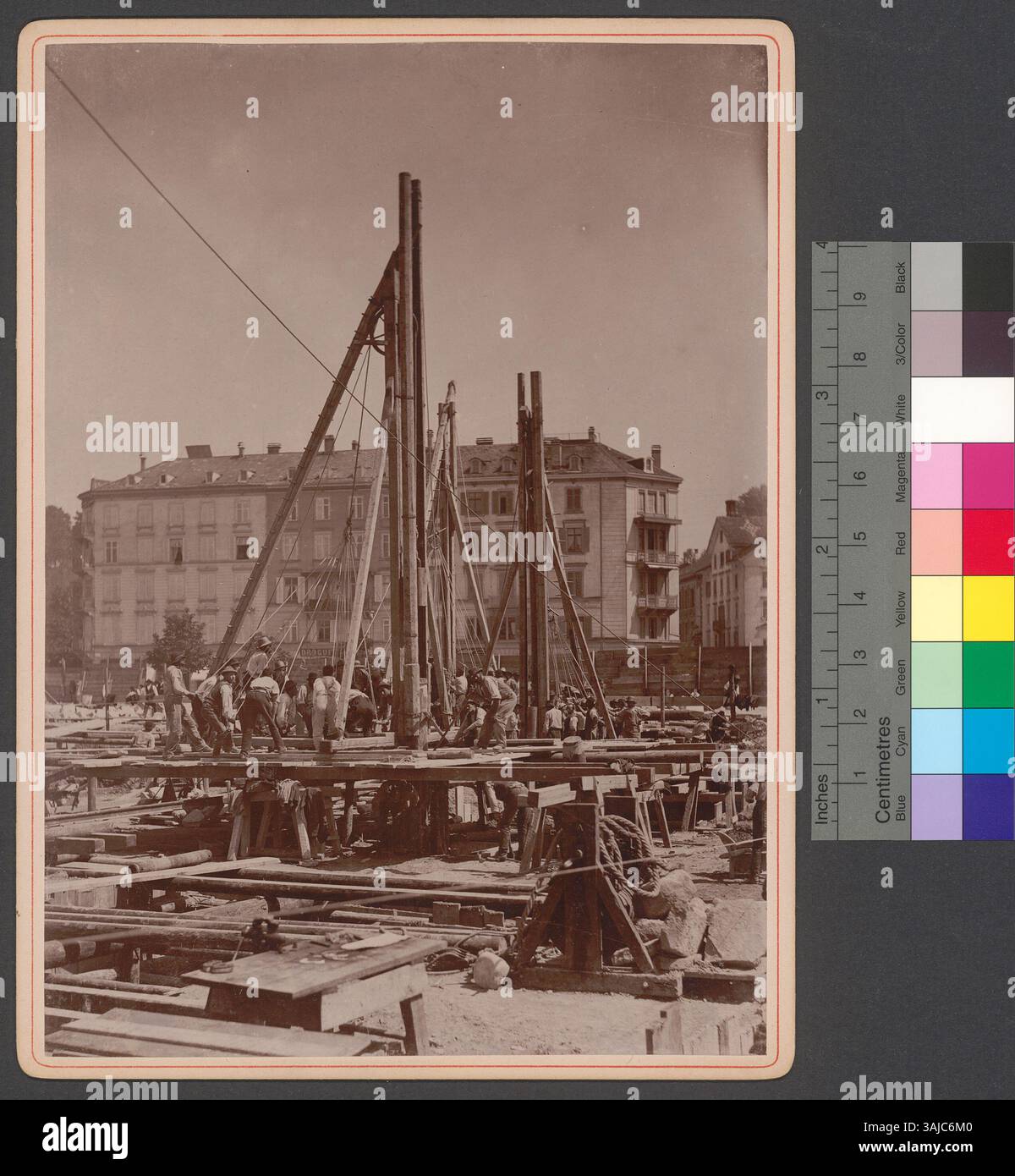 This 1890 photograph by Robert Breitinger shows workers using a rammer ...
