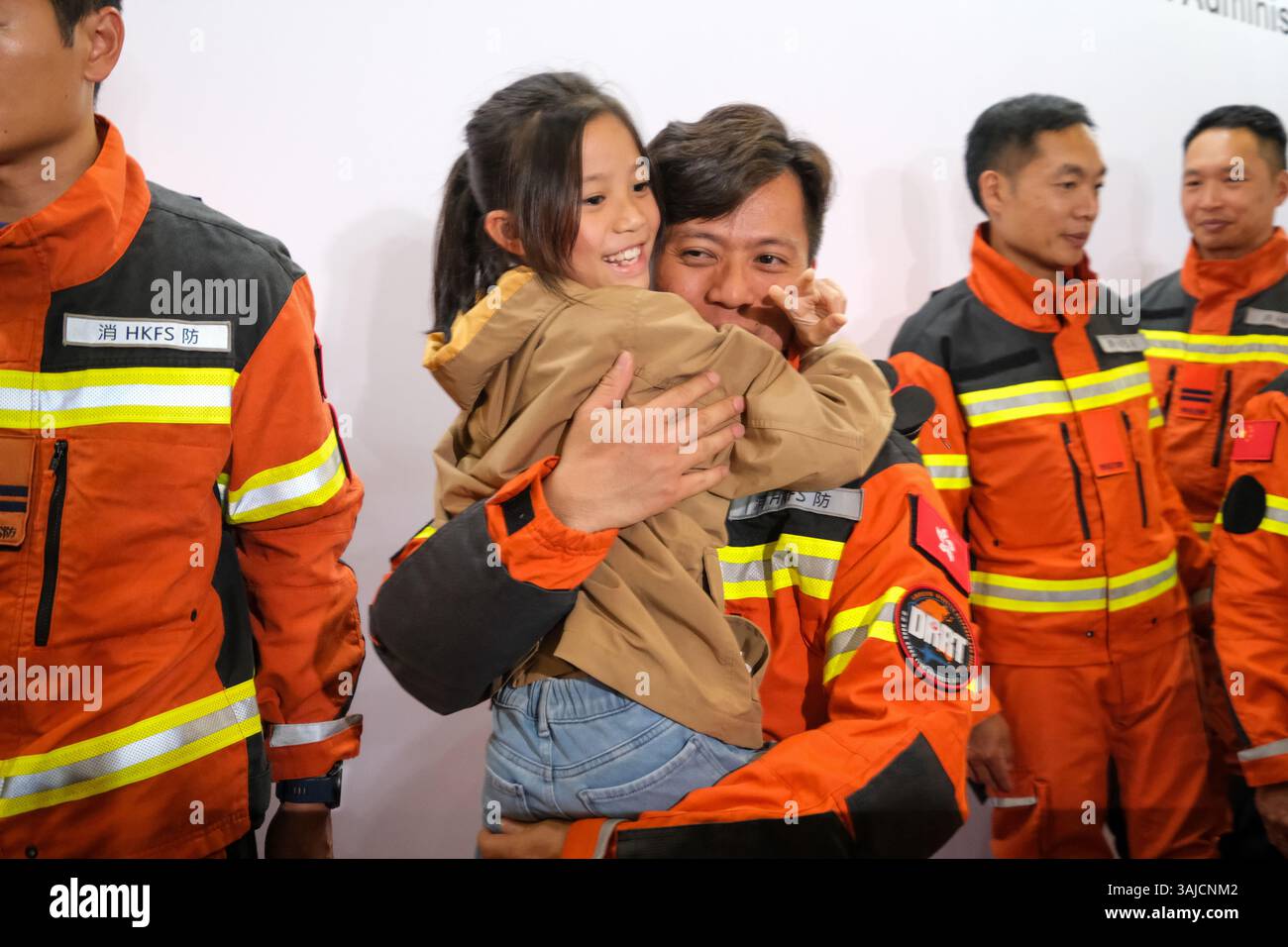 A member of the Hong Kong rescue team hugs his daughter, April 9, 2025. Hong Kong,China.9th ...
