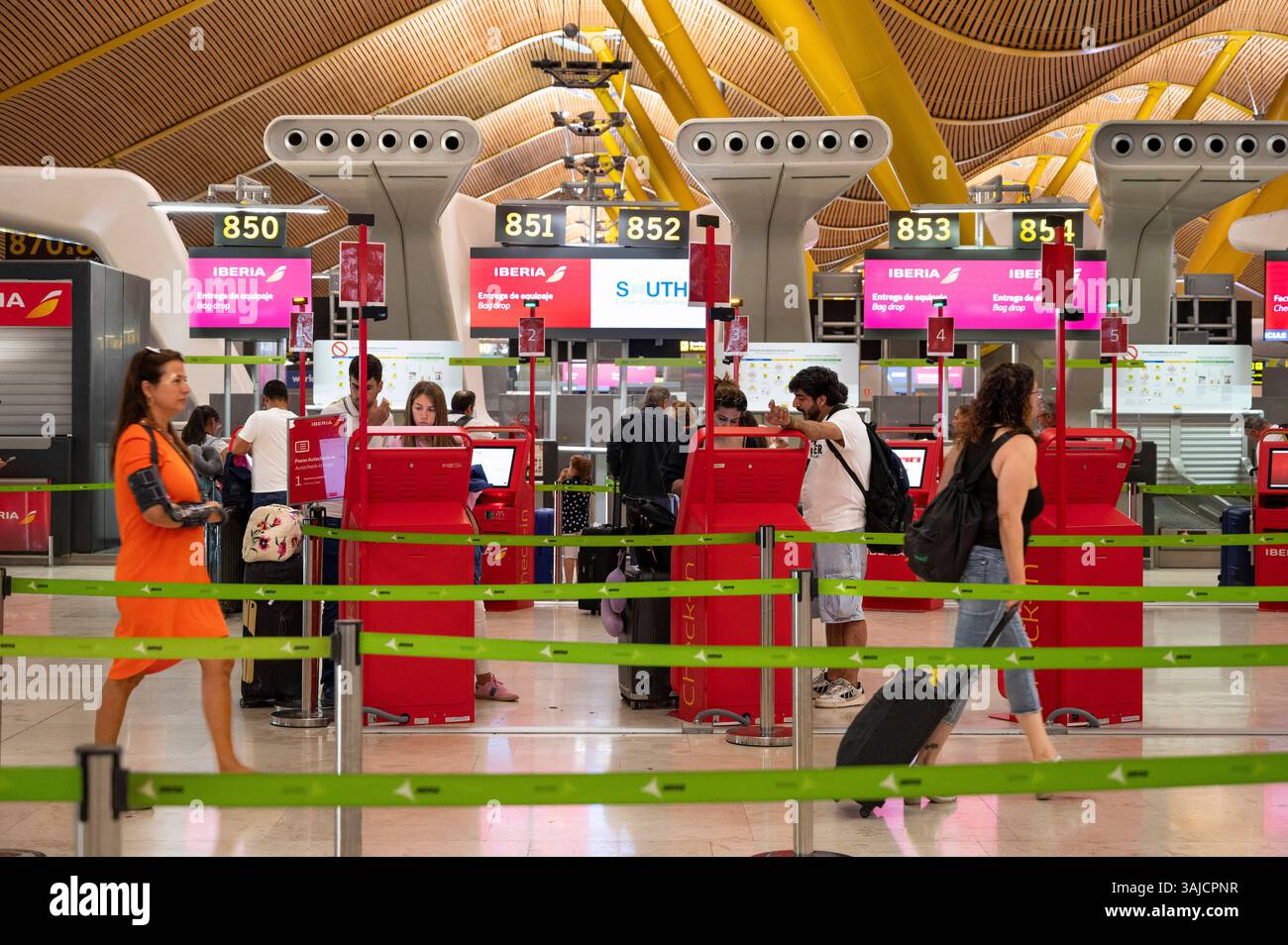 Madrid, Spain. 10th Apr, 2025. Travelers use self check-in machines ...