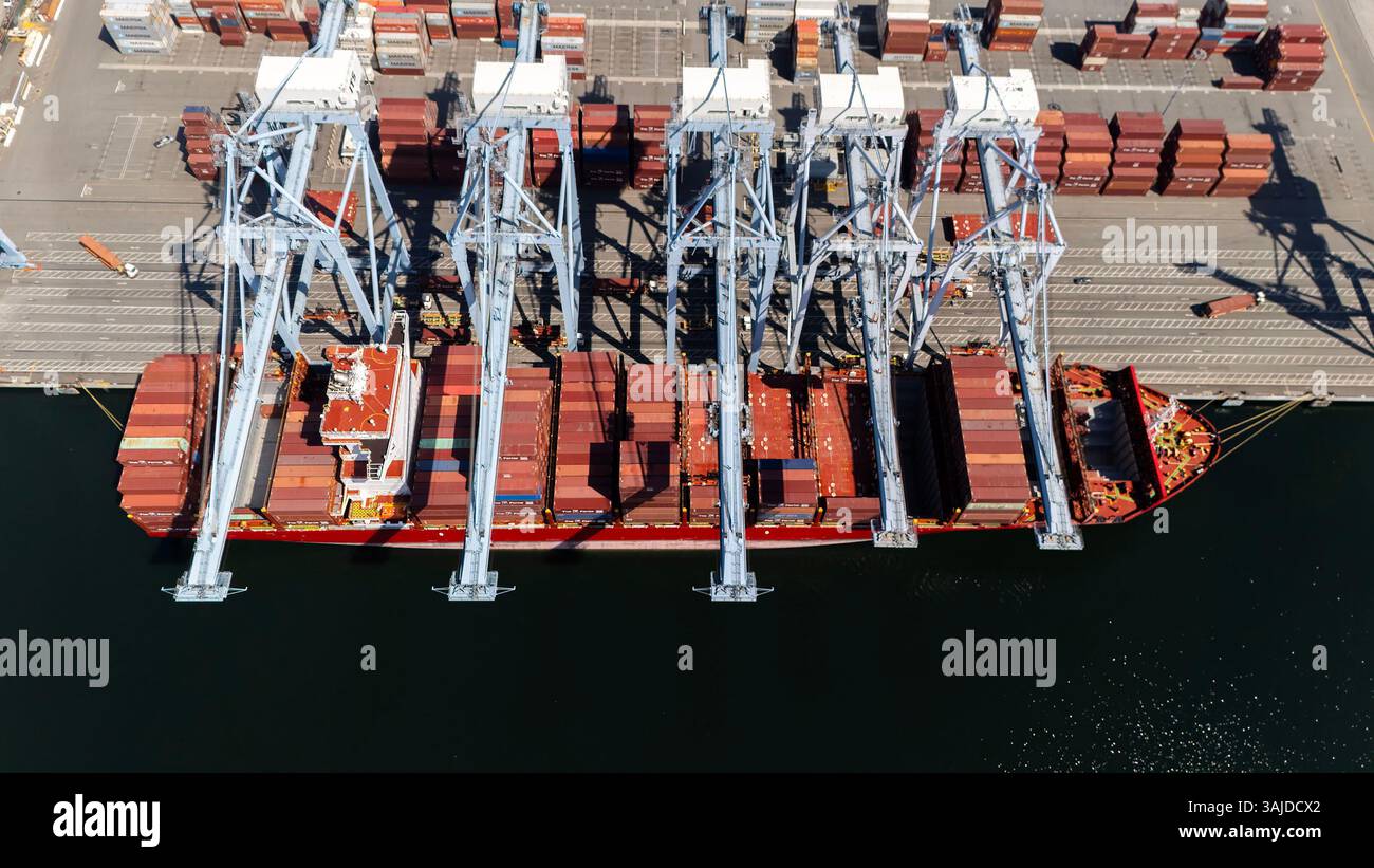 An aerial view of the Port of Long Beach reveals a vast, bustling trade ...