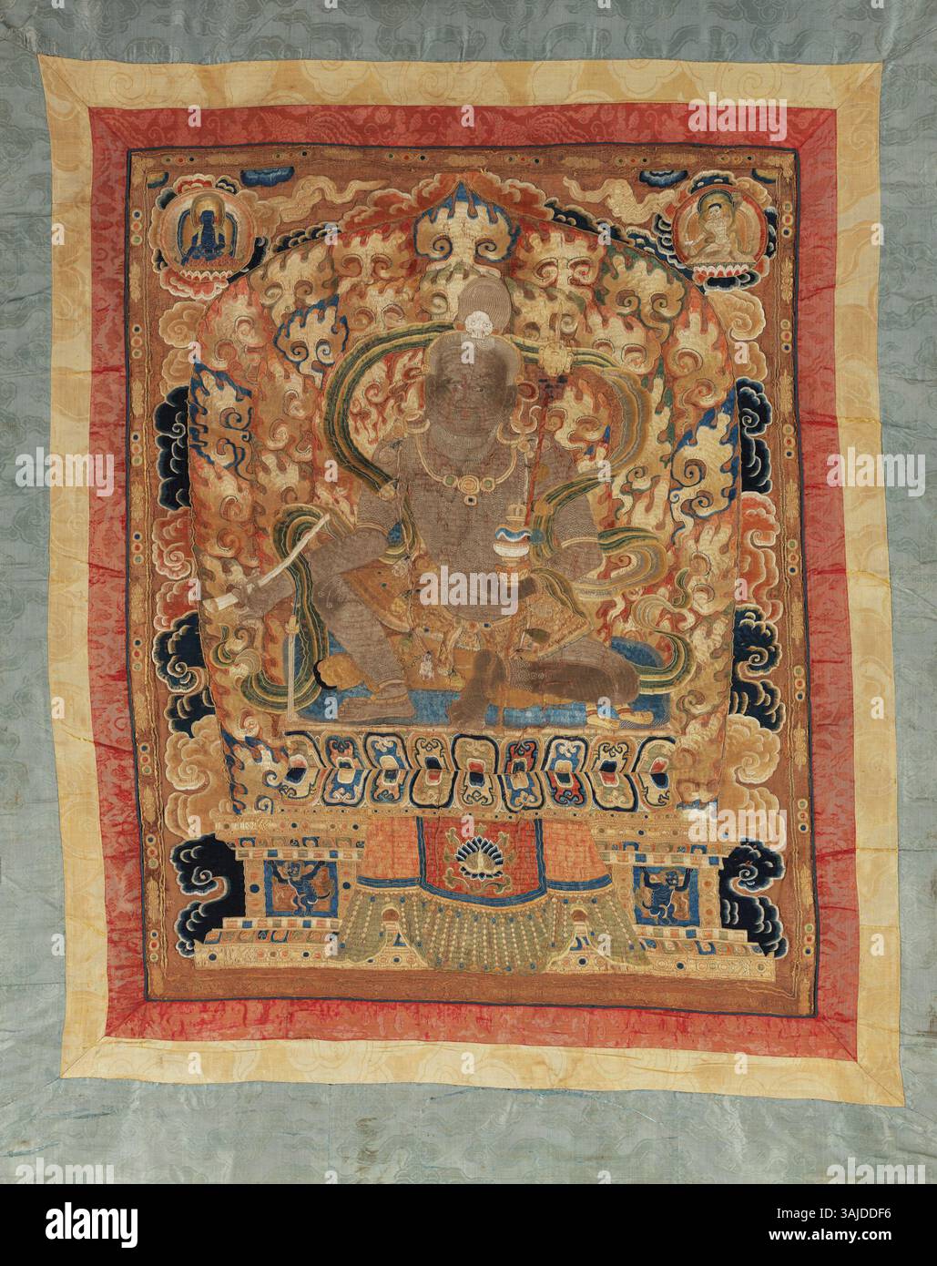 This embroidered silk hanging scroll, dated 1517, features a Mahasiddha ...