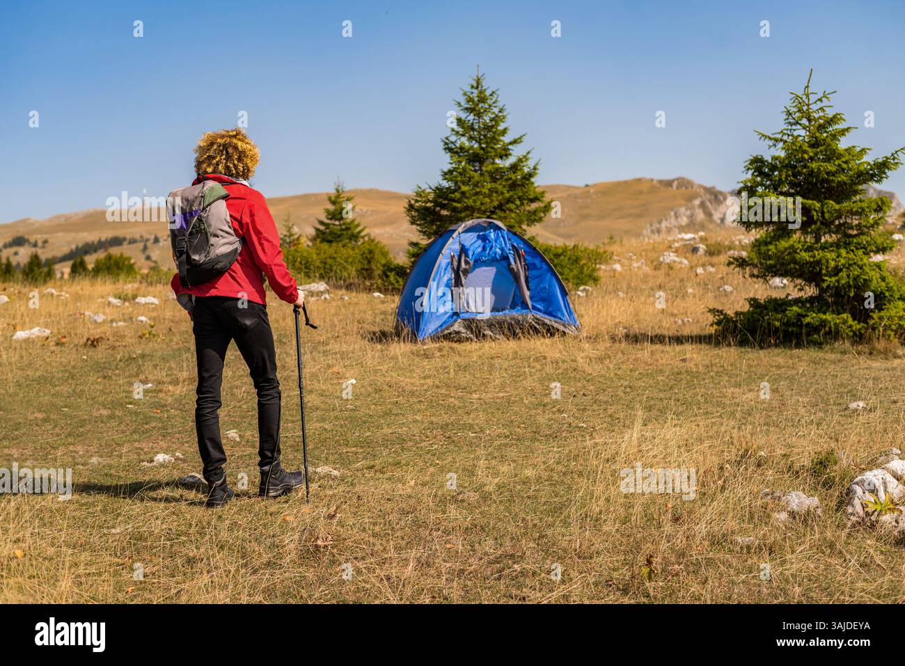 A male hiker solo camping and hiking in the mountain forest adventure ...