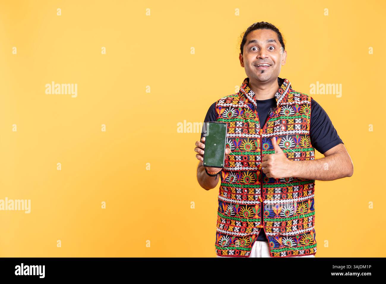 Portrait of influencer smiling and doing thumbs up gesturing presenting ...