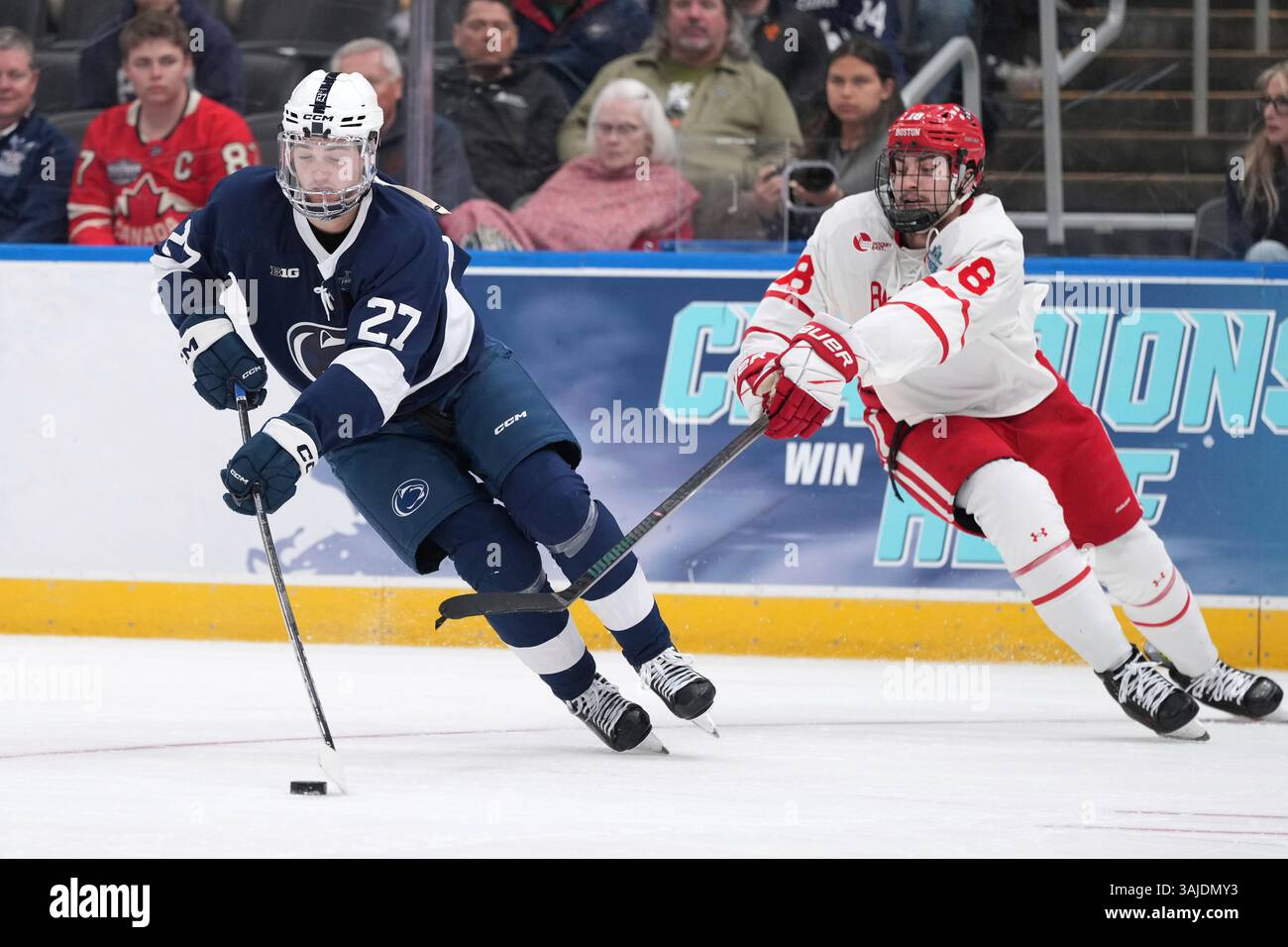 Penn State's Cade Christenson (27) handles the puck as Boston ...