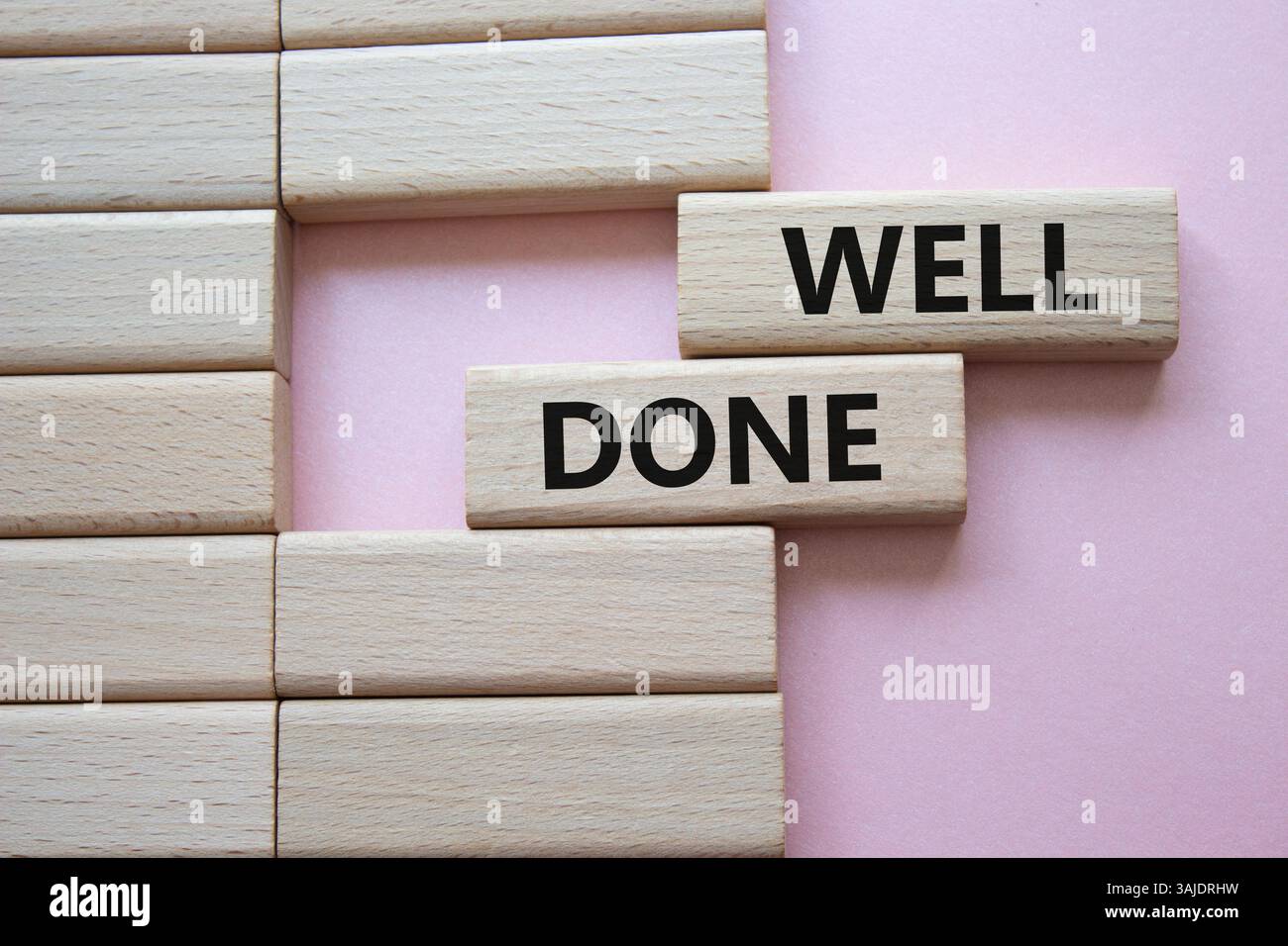 Well done symbol. Wooden blocks with words Well done. Beautiful pink ...