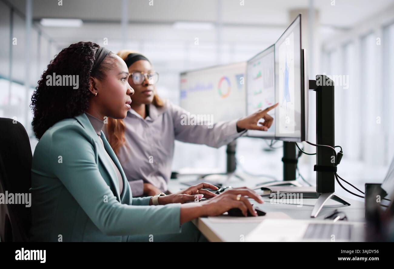 Female Corporate Analyst Managing Market Data on Multiple Computer ...