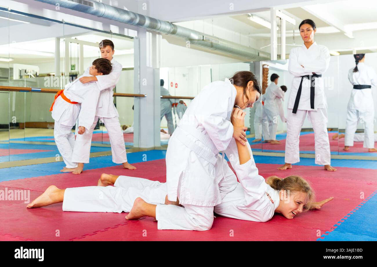 Boys performing arm lock movement during karate training Stock Photo ...