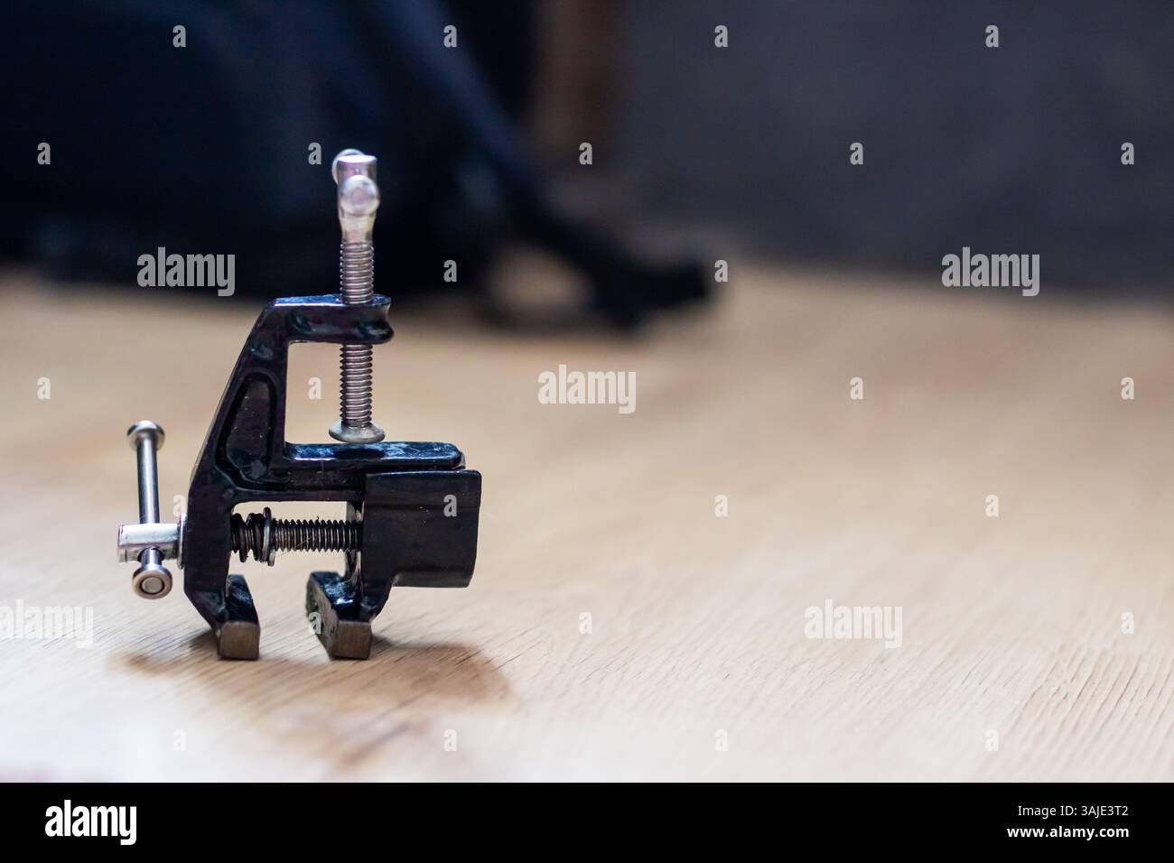 A sturdy clamp featuring a screw that is securely attached to it is ...