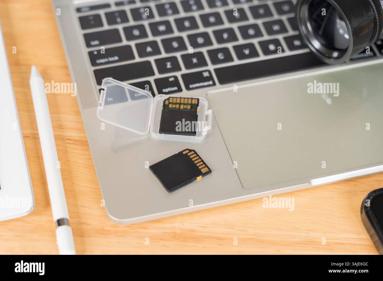 Laptop, external hard drive, modern digital camera with flip screen ...