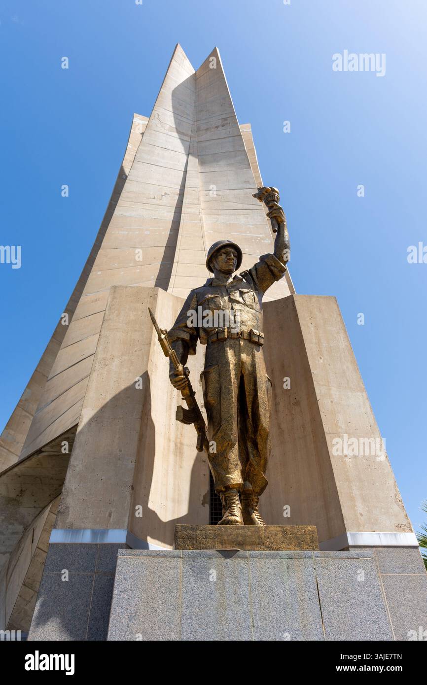 A soldier statue made of bronze holding a torch and gun in the Maqam ...