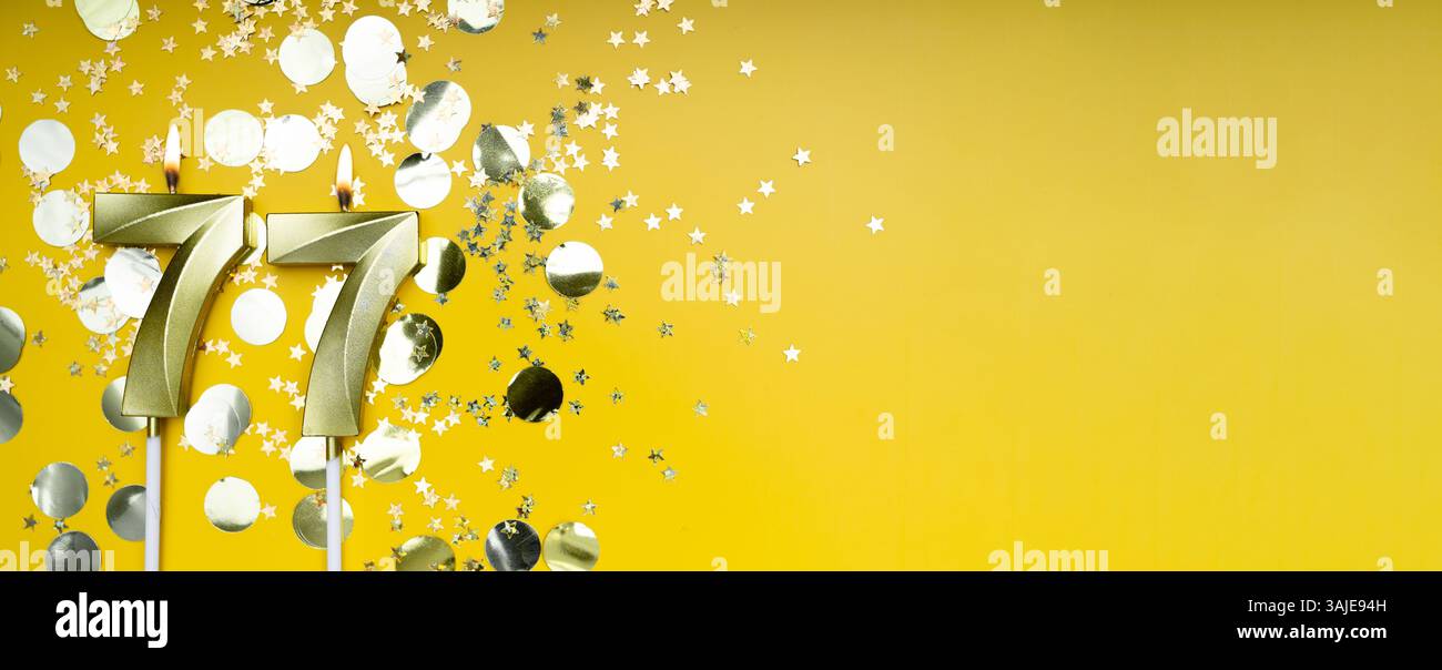 Seventy-seven years birthday. Number 77 golden celebration candle ...