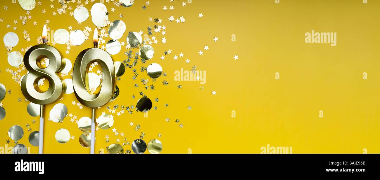 Eighty years birthday. Number 80 golden celebration candle. Yellow ...