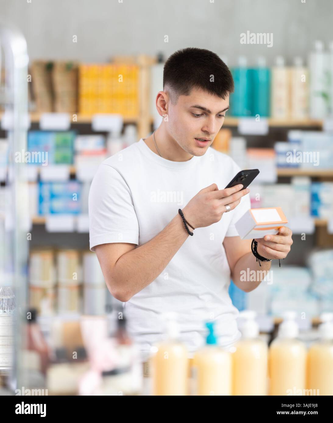 Handsome young guy choosing box with pills to improve well-being in ...