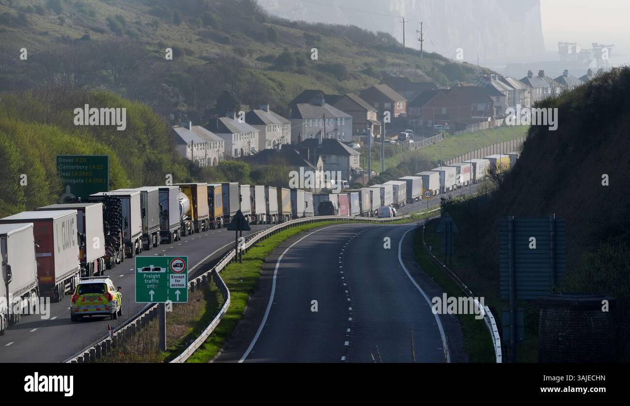 Lorries queue along the A20 outside Dover in Kent as the TAP traffic ...