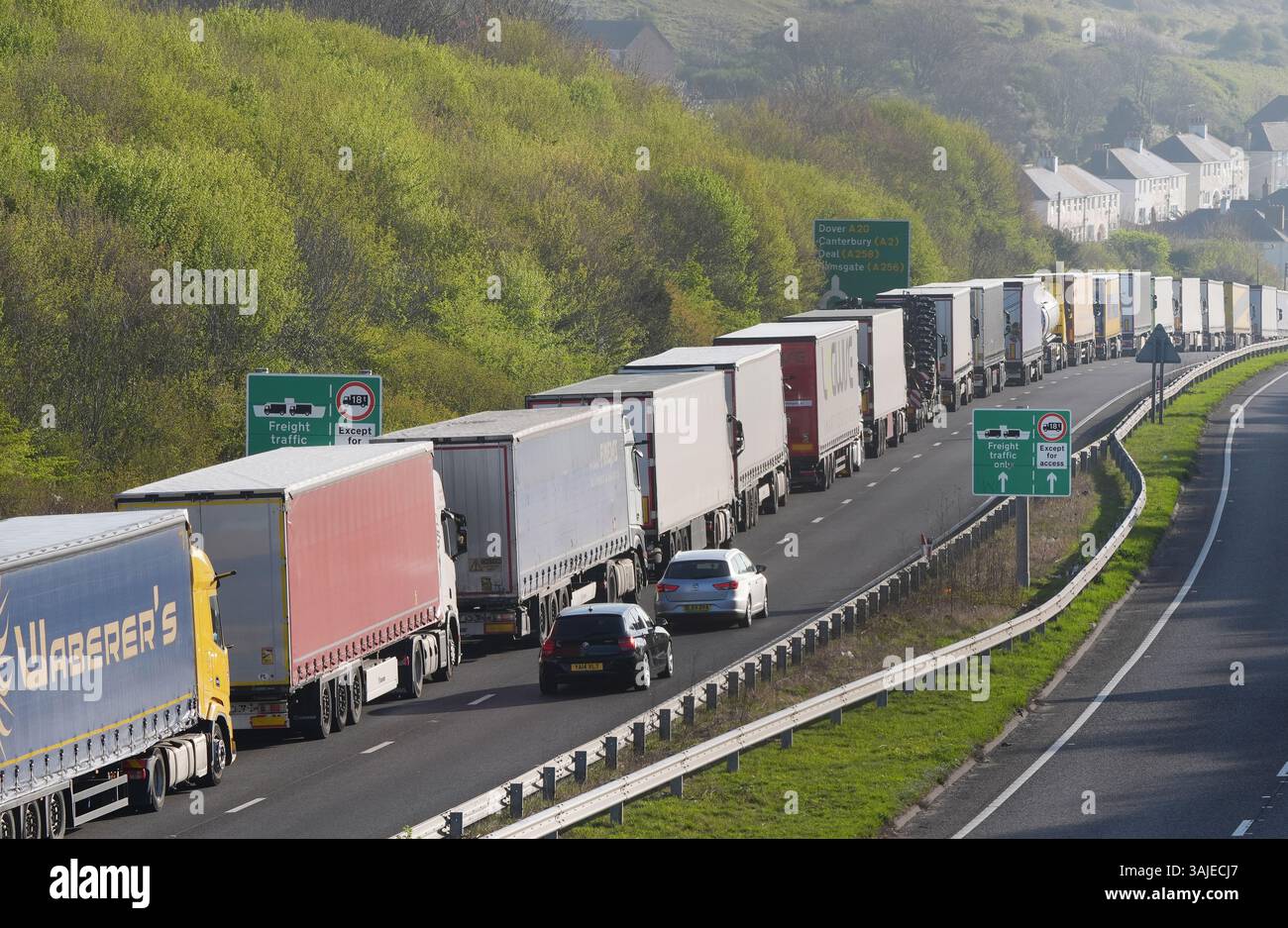 Lorries queue along the A20 outside Dover in Kent as the TAP traffic ...