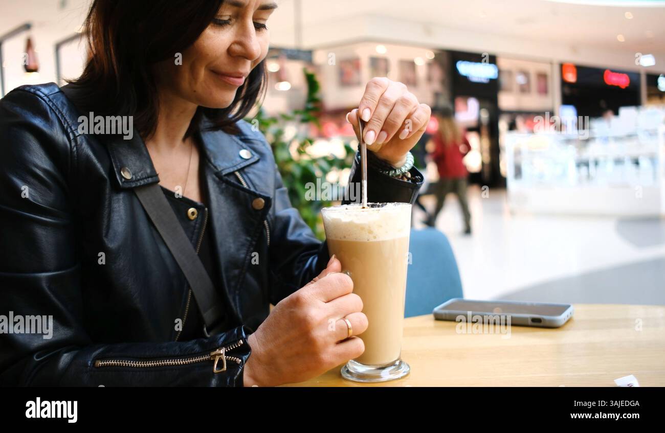 Stylish Woman Drinking Latte Coffee In A Cafe In The Trade Center Stock ...