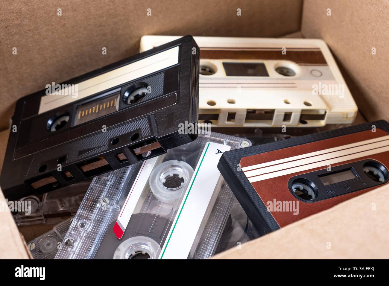 A Heap of an Old Audio Tape Cassettes in the Cardboard Box closeup ...
