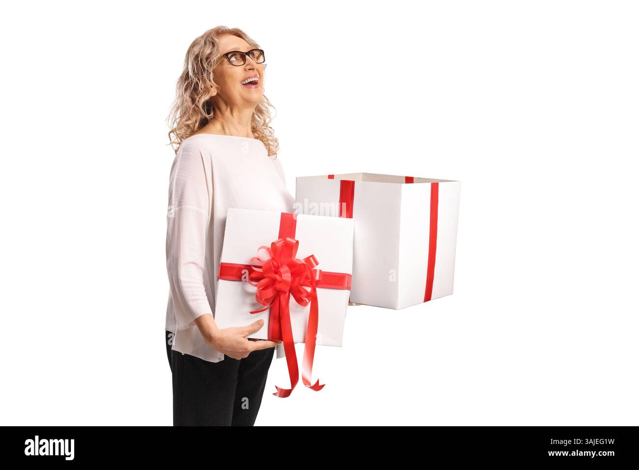Excited woman opening a present box and looking up isolated on white ...
