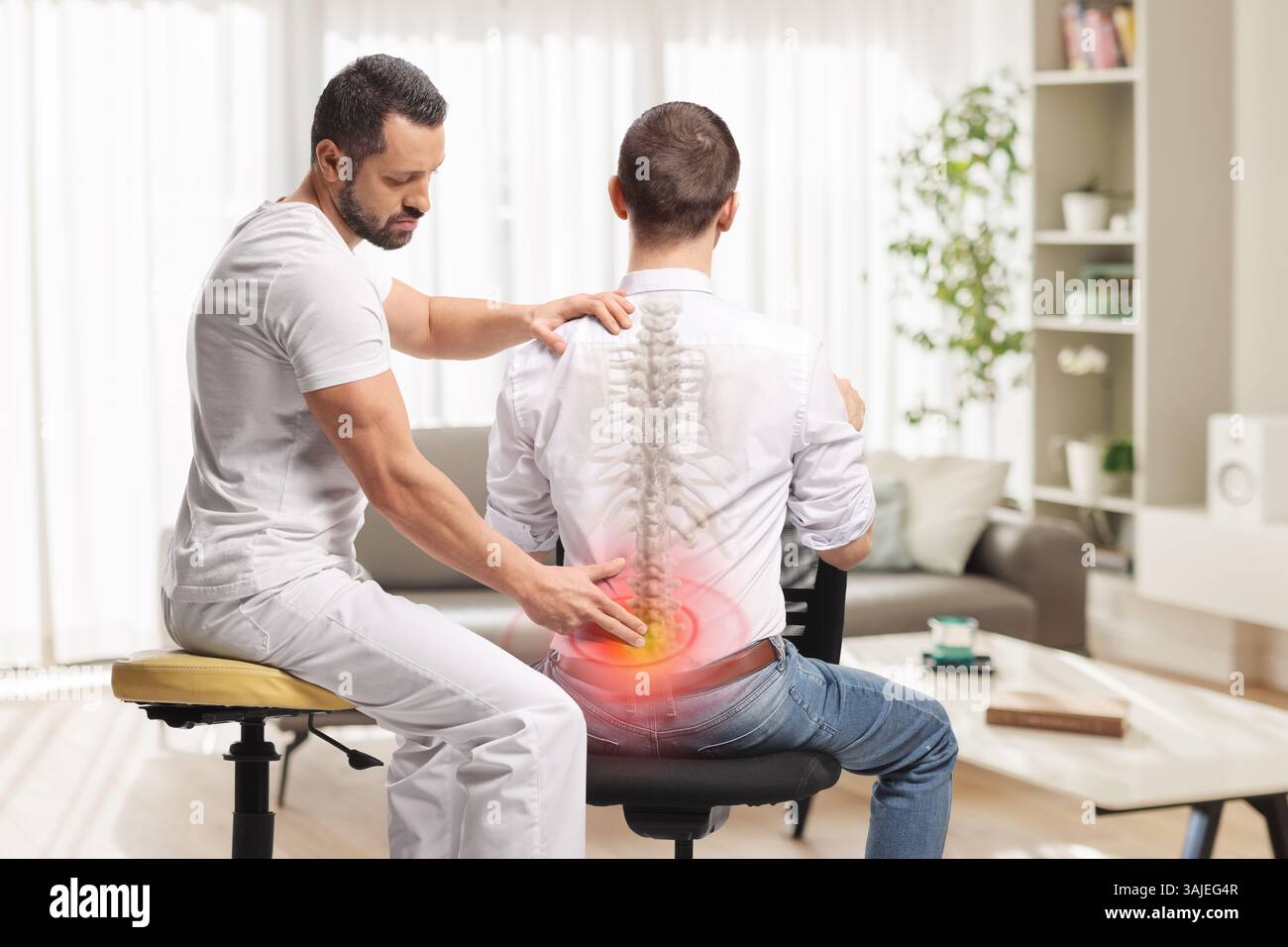 Chiropractor treating a young man with backpain seated in a chair Stock ...