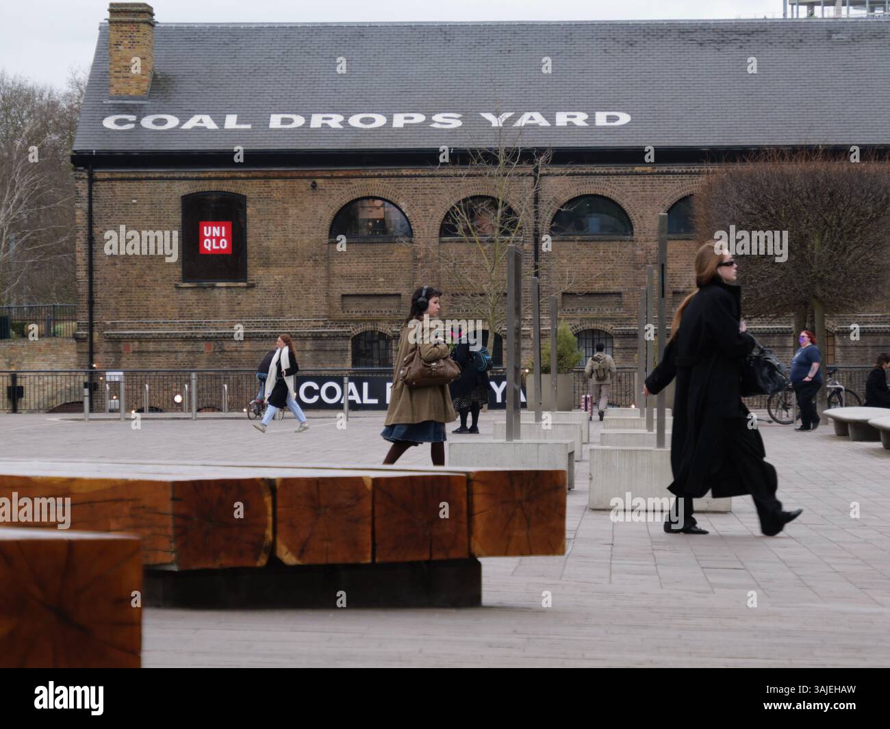 Pedestrians and commuters walk through Coal Drops Yard, Granary Square ...