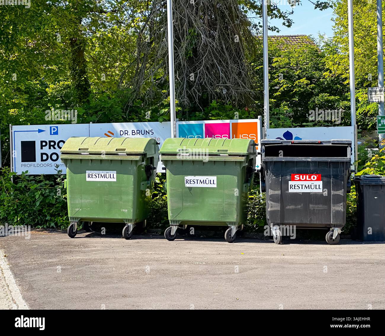 Baden Baden, Germany - May 10, 2024 - Two green and one black garbage ...