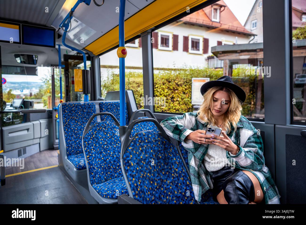 Woman using her smartphone while commuting by bus in Stuttgart, Germany ...