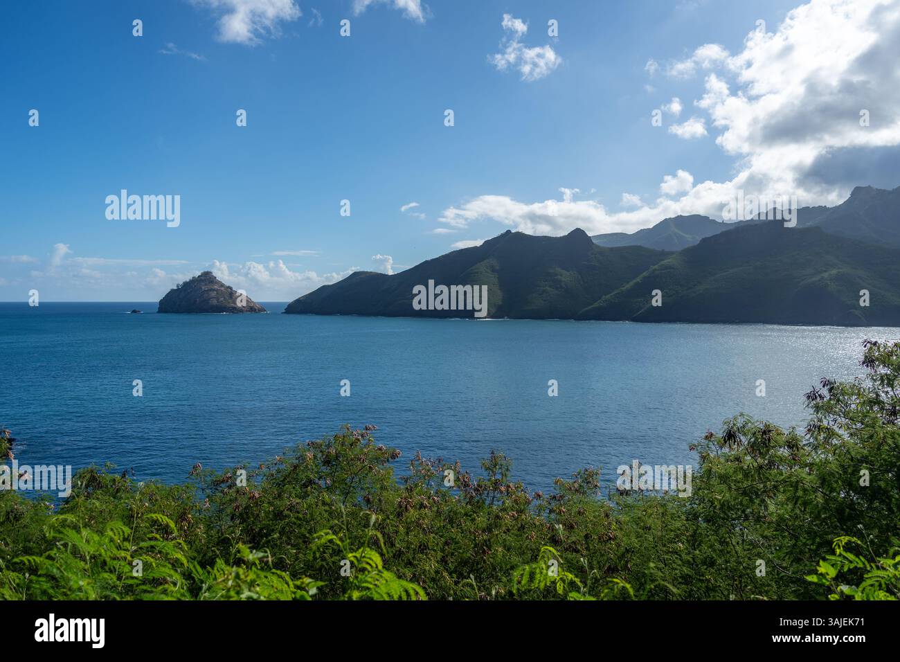 The rugged cliffs of Taiohae Bay in Nuku Hiva, Marquesas Islands, drop ...