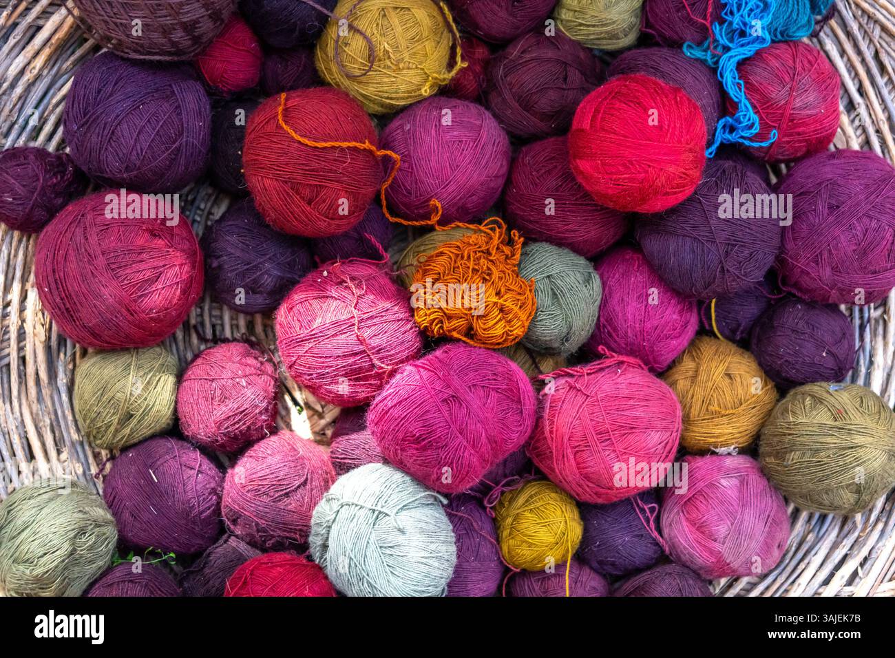 Hand-dyed wool balls in various shades of red, yellow, blue, and purple ...